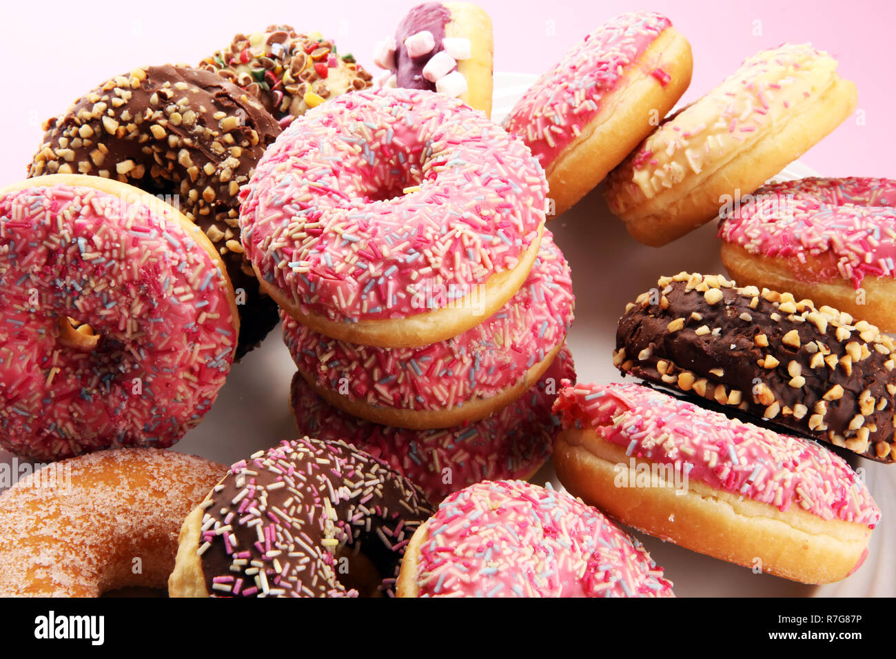 assorted donuts with chocolate frosted, pink glazed and sprinkles ...