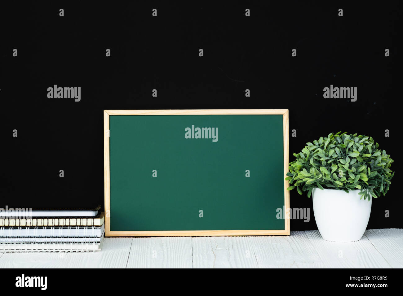 Back to school and education concept idea, green chalkboard with pile ...