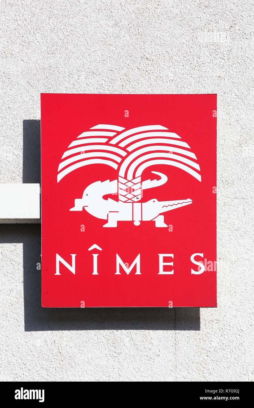 Emblem on a wall of the city of Nimes in France Stock Photo - Alamy