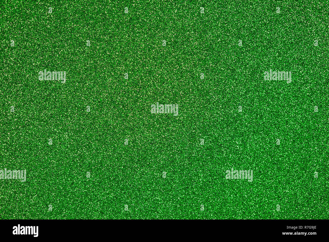 Lime green colored sand paper textured background with sparkles and ...