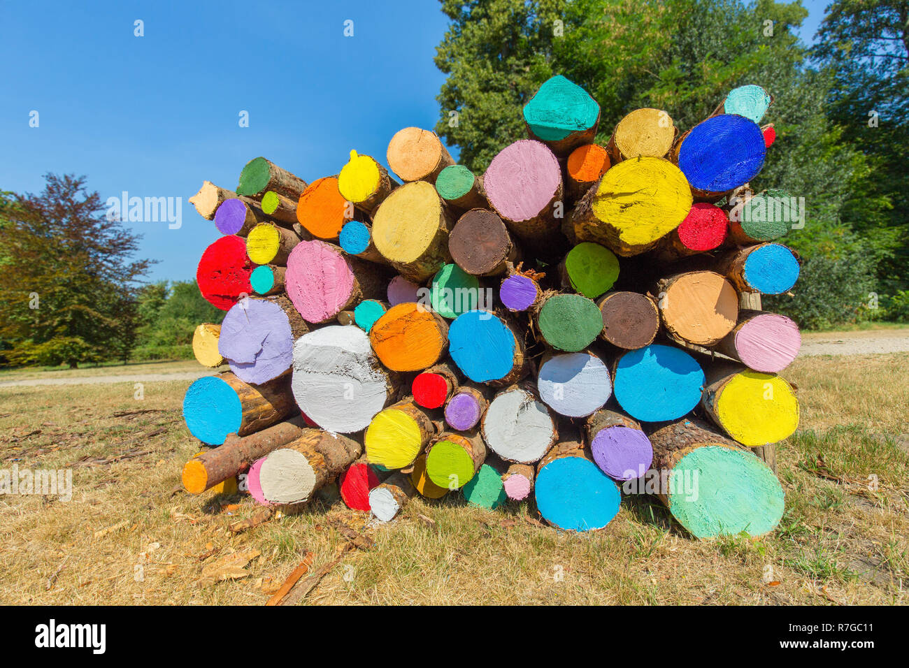 stack of painted tree trunks with various colors in park Stock Photo ...
