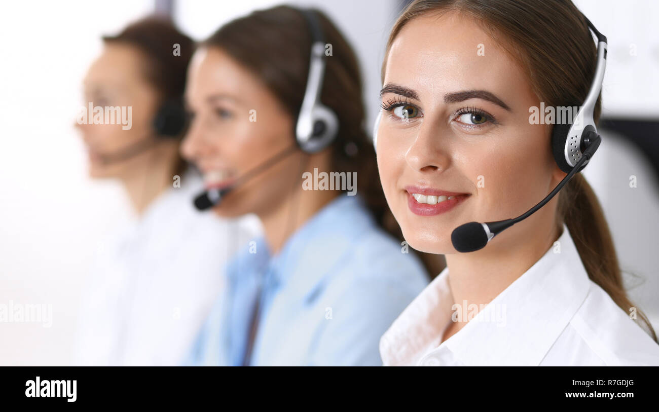 Call center. Group of operators at work. Focus at beautiful business woman in headset Stock ...