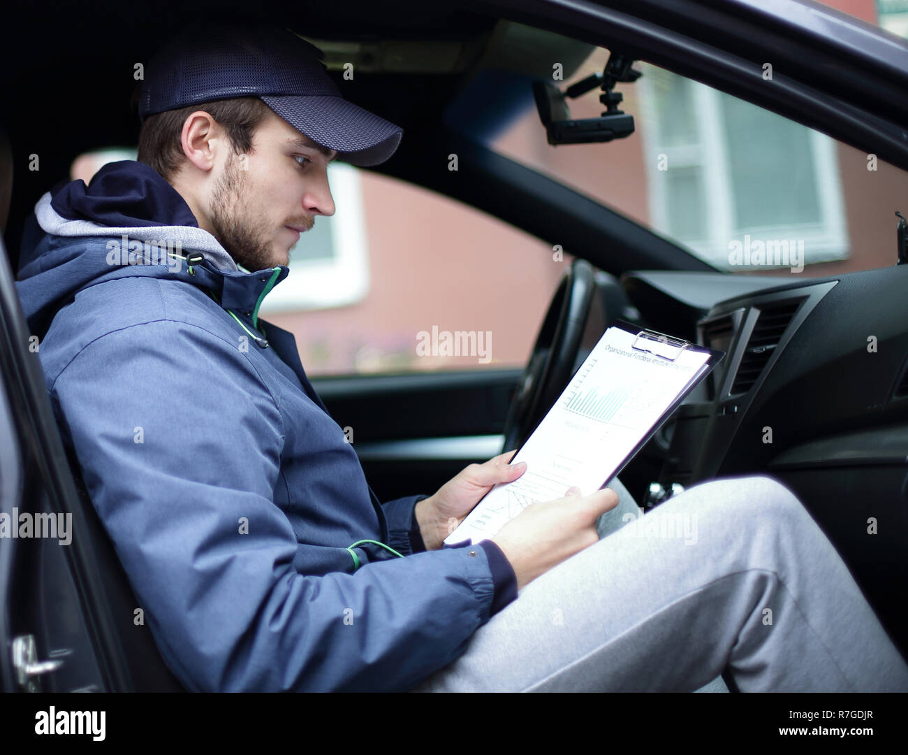 man with documents sitting in the car Stock Photo - Alamy
