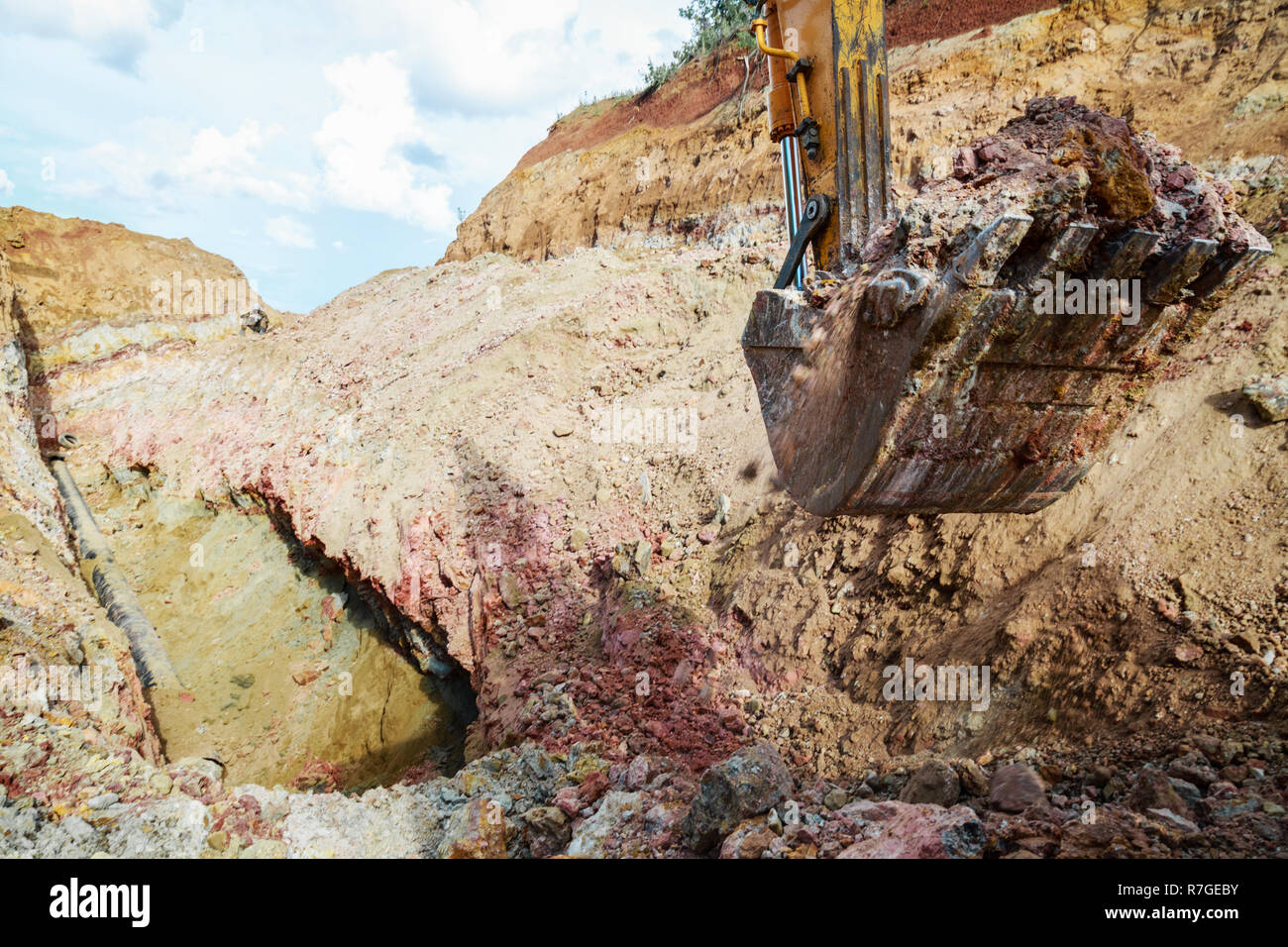 Excavator digging a trench for the pipeline. Bucket closeup Stock Photo ...