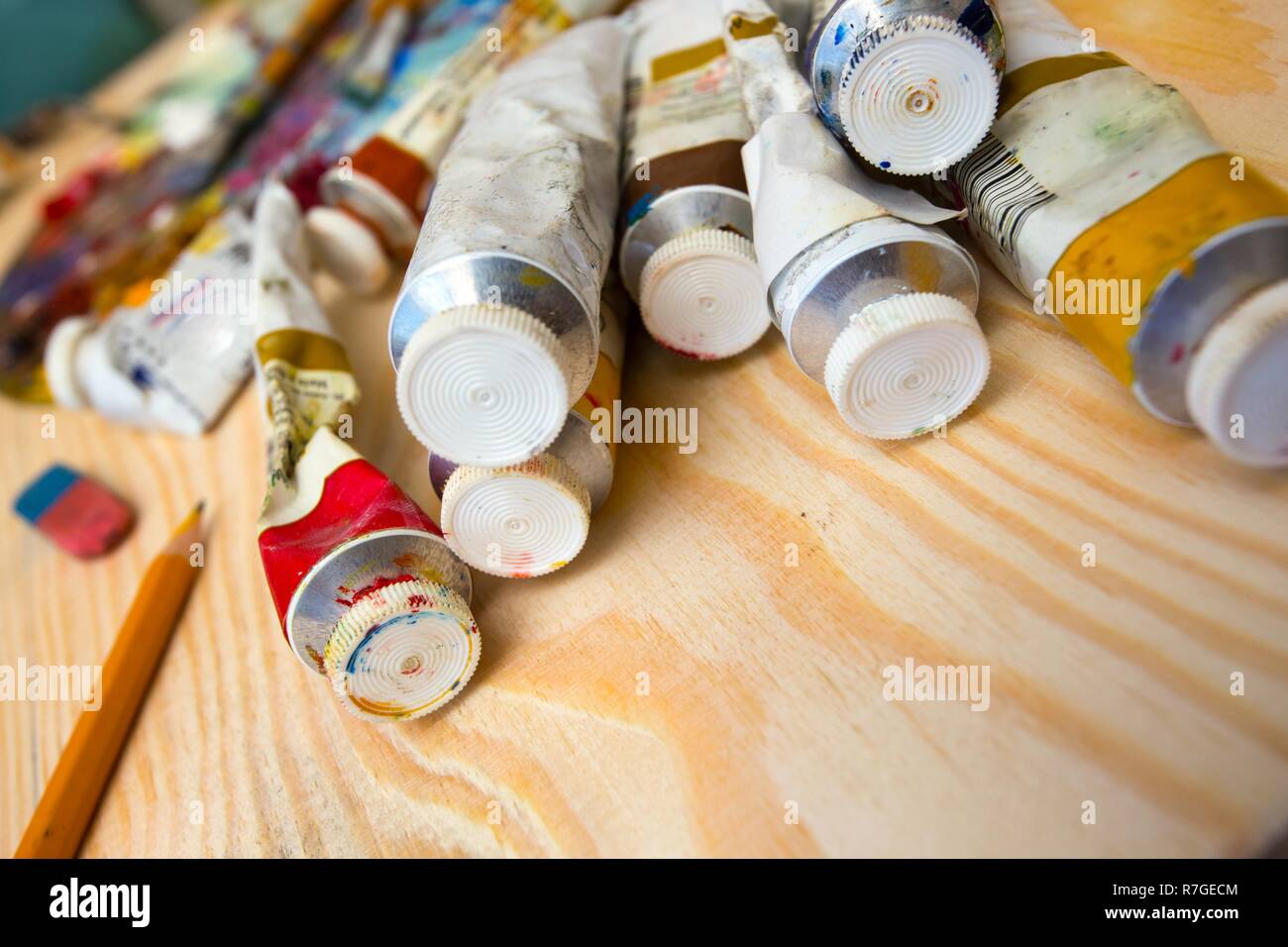tubes of paint on a wooden table Stock Photo - Alamy