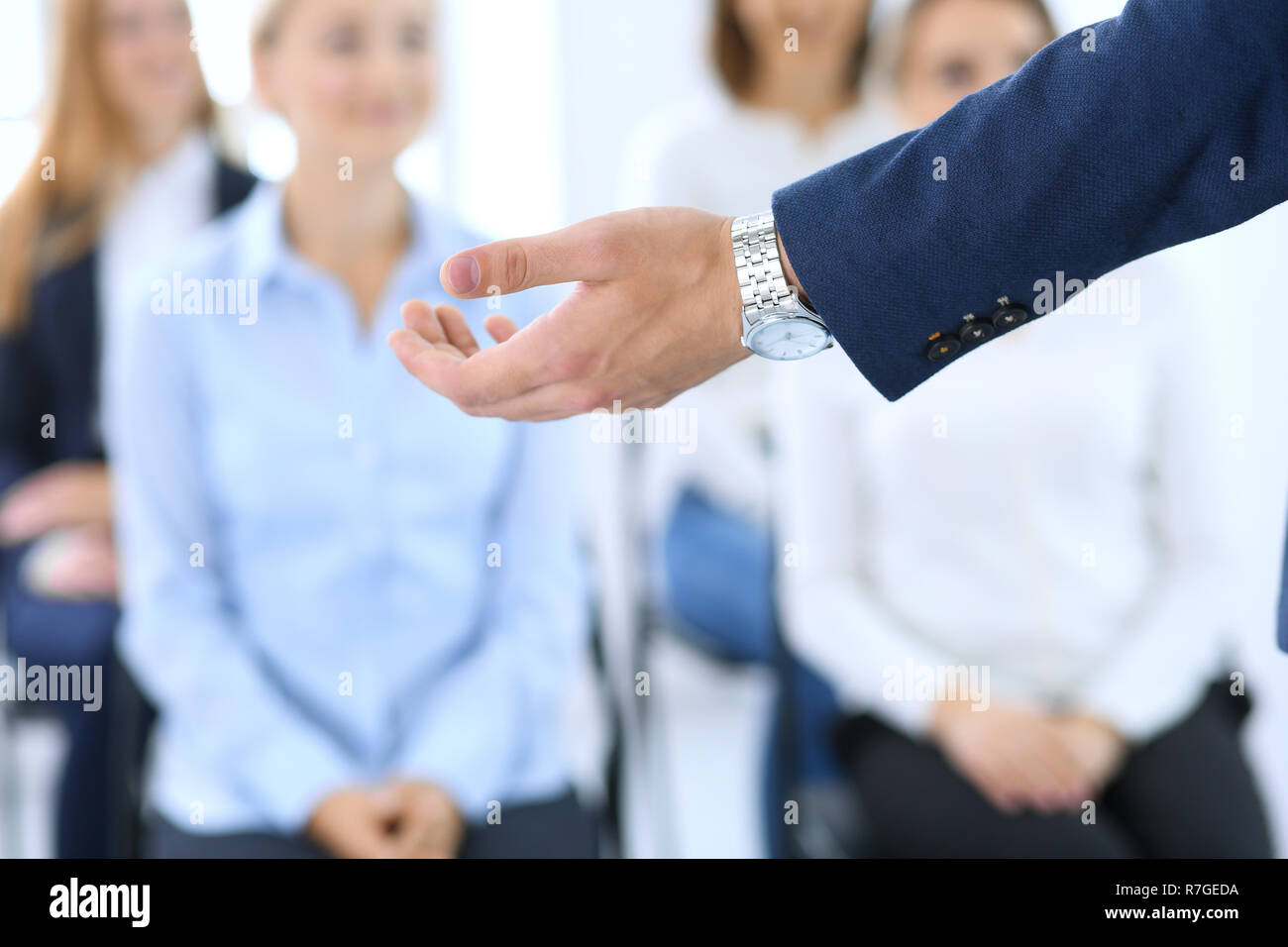 Business man making presentation to group of people. Speaker delivering ...