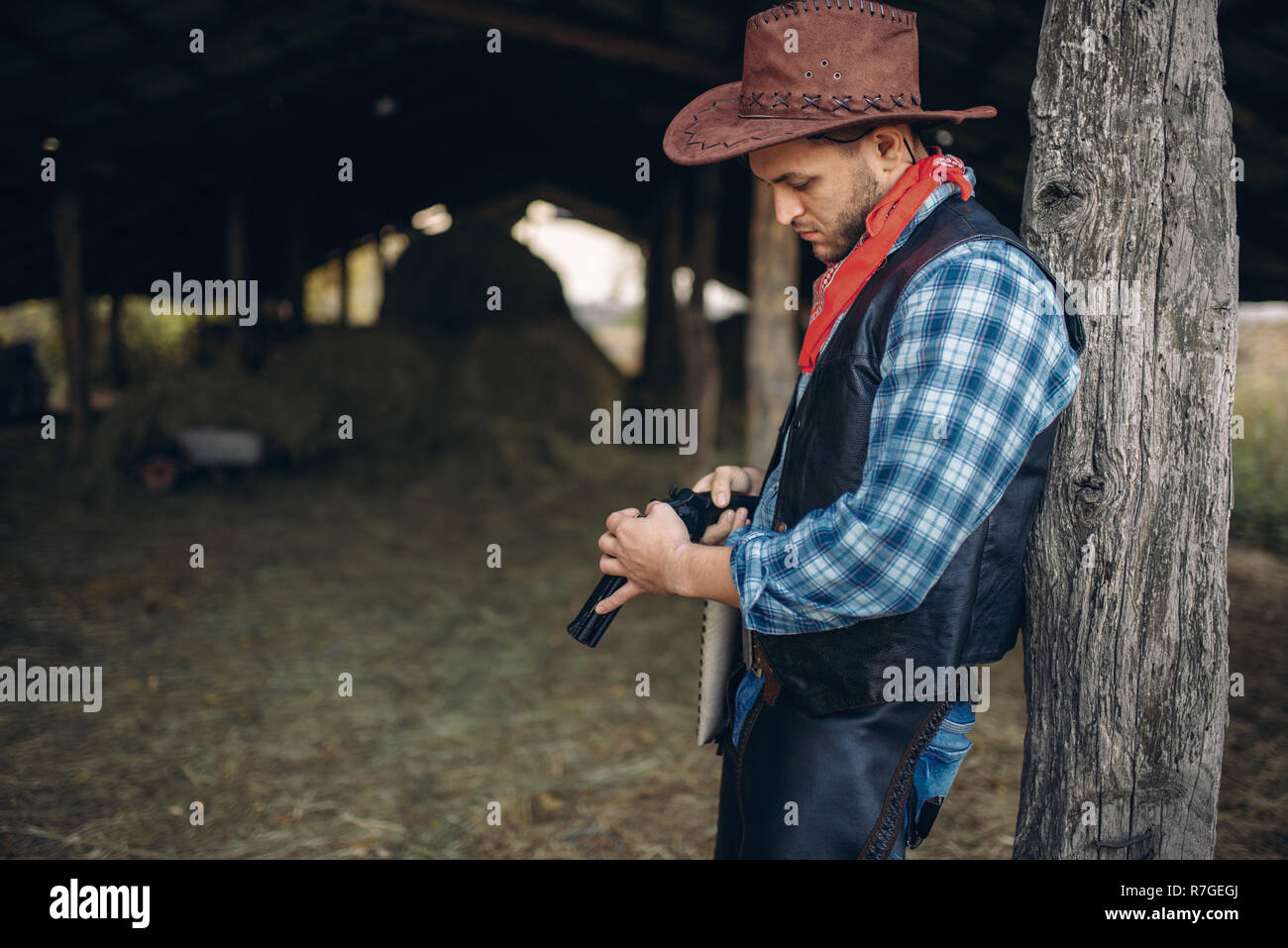 Brutal cowboy checks his revolver before gunfight, texas ranch on ...