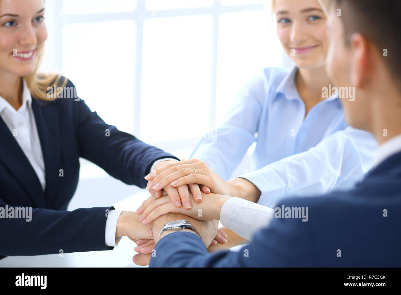 Business team showing unity with their hands together. Group of people ...