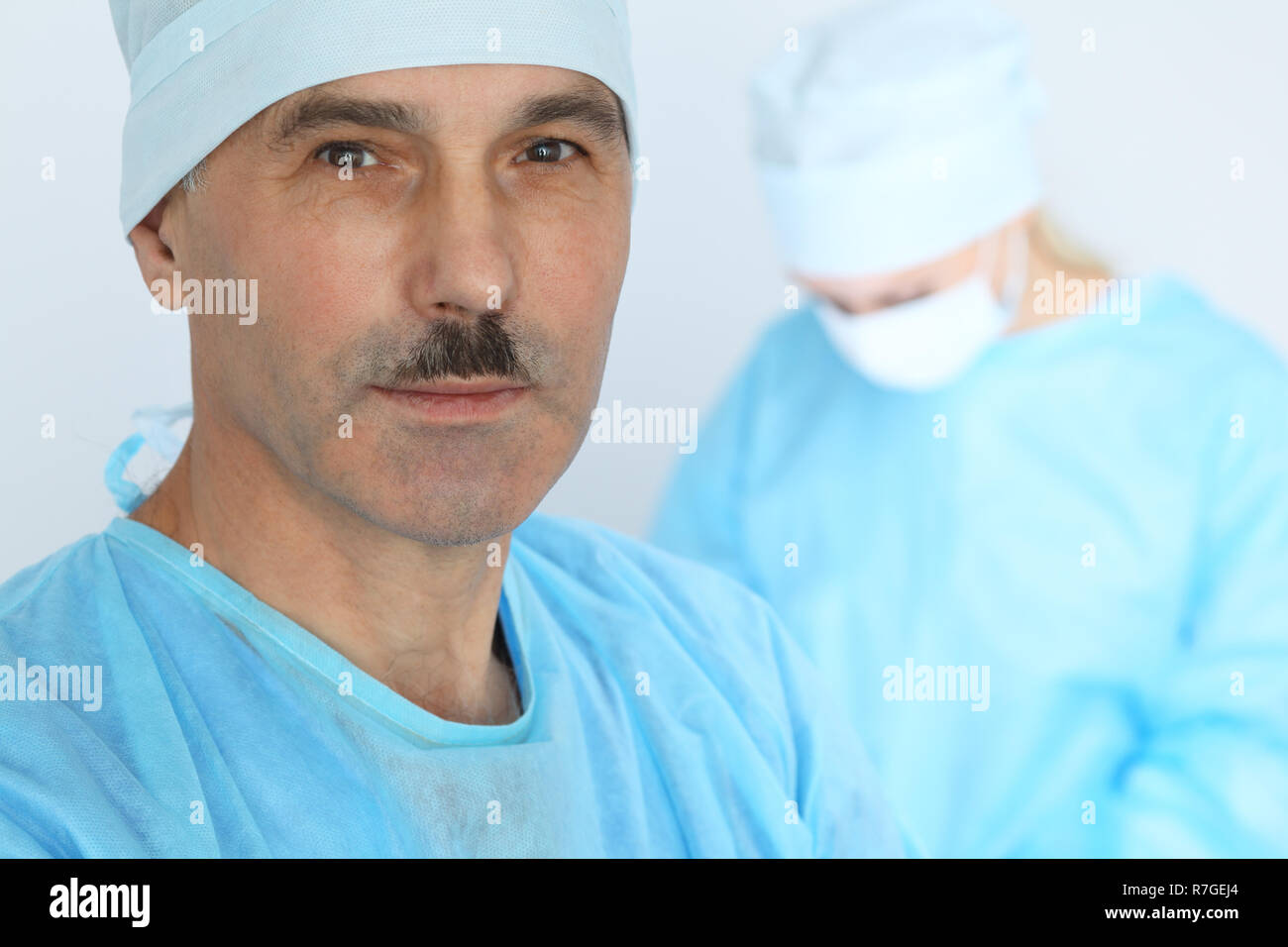Boss surgeon is examining the operation while medical team are busy of ...