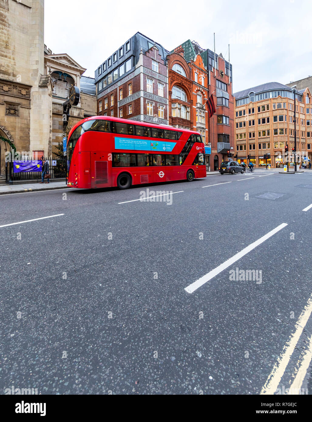 Modern red London buses passing the DC Thomson building on Fleet Street ...
