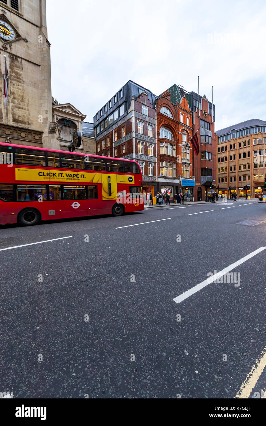 Modern red London buses passing the DC Thomson building on Fleet Street ...