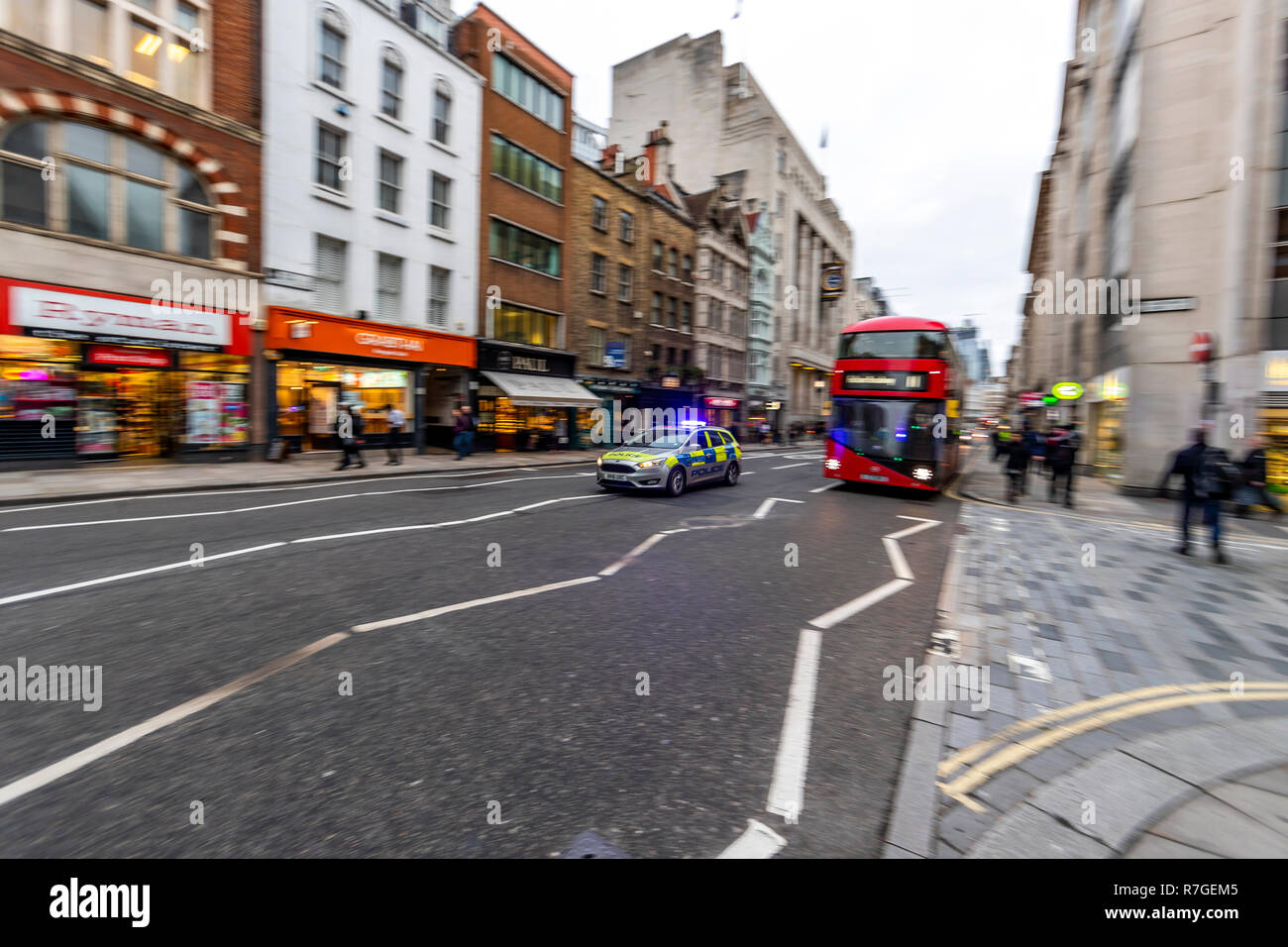 Police car responding with blue lights and sirens, Fleet Street, London ...