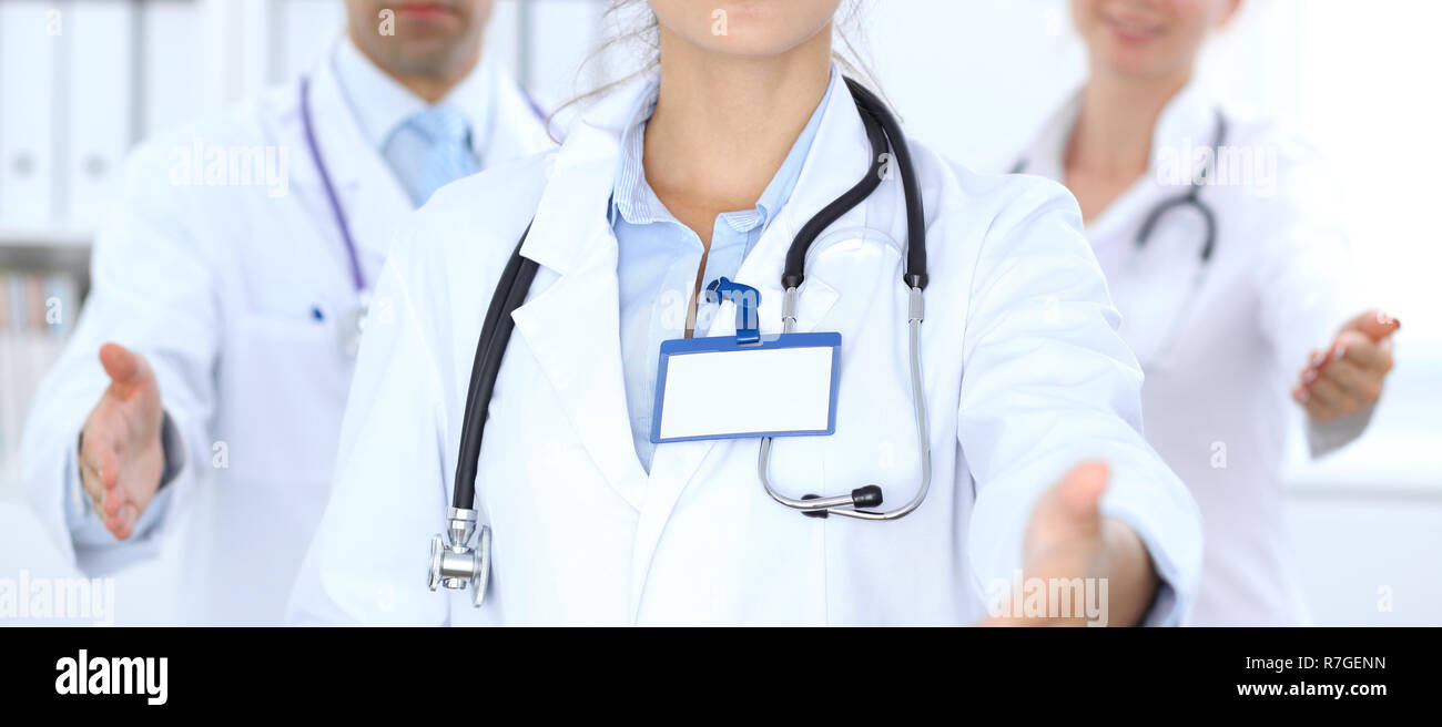 Happy doctor woman with medical staff at the hospital. Helping hand ...