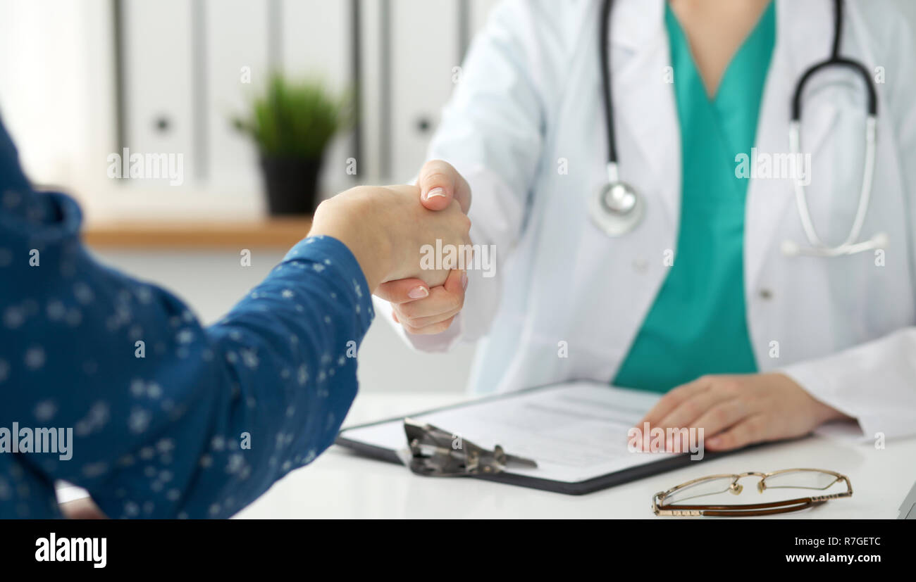 Doctor and patient shaking hands. Partnership, trust and medical ethics ...