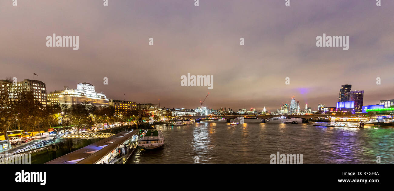 MBNA Thames river boats at the Embankment Pier. Waterloo Bridge in the ...