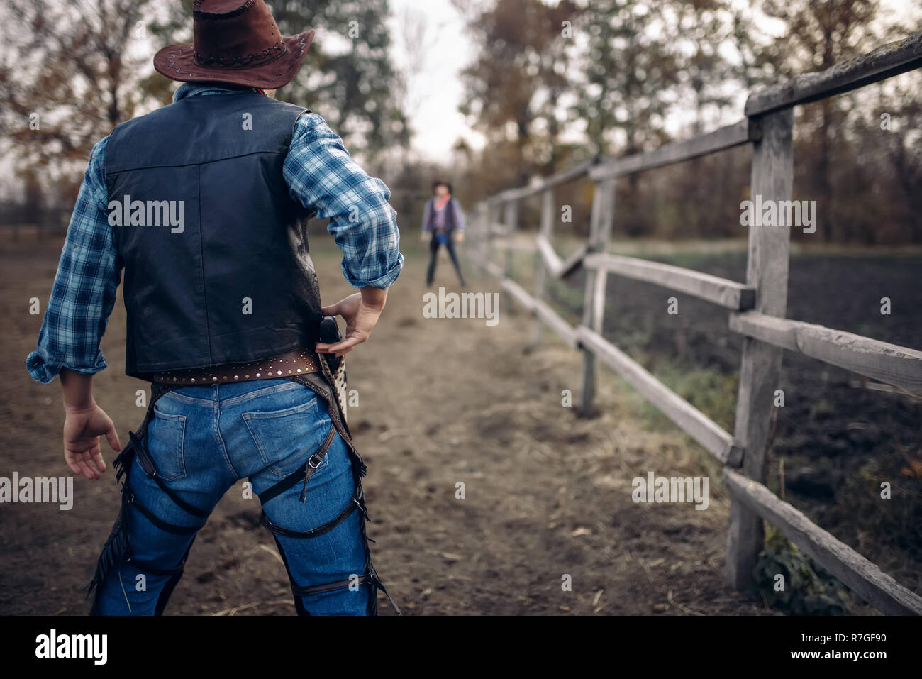 Cowboy with gun prepares to gunfight, back view, lucky strike on texas ...