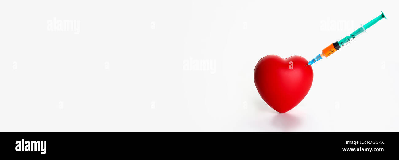 Red heart with stuck syringe on gray background Stock Photo - Alamy
