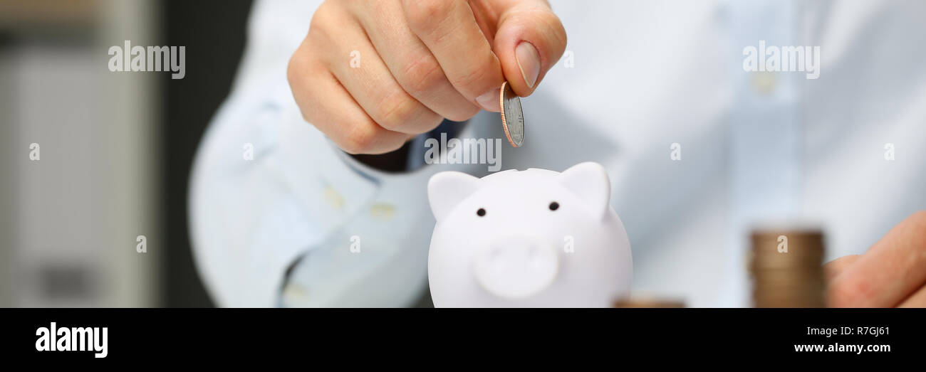 Hand businessman putting pin money Stock Photo - Alamy