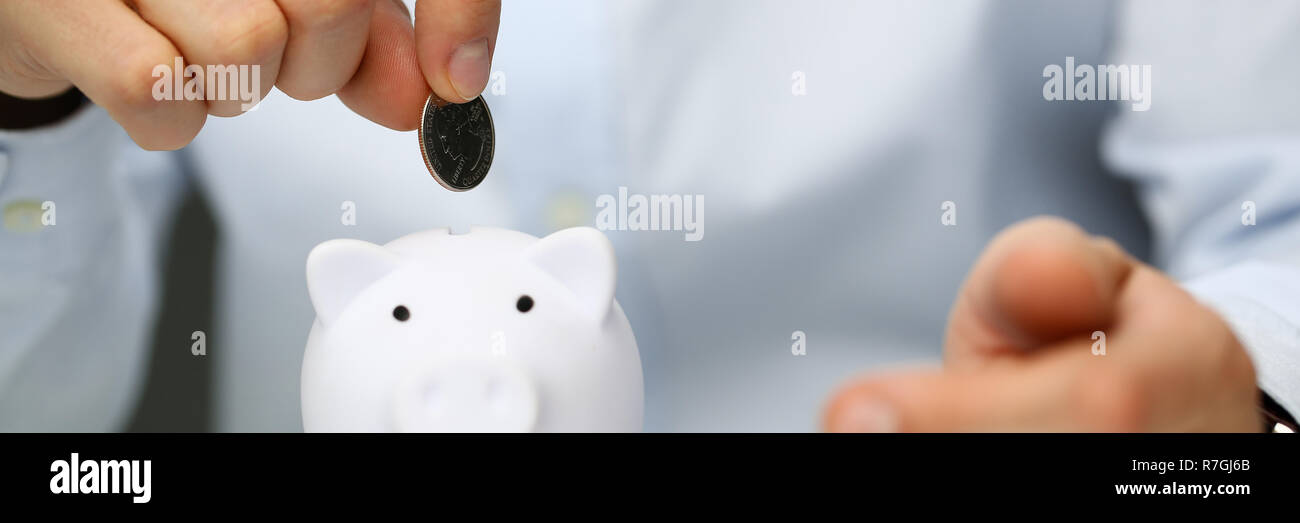 Hand businessman putting pin money Stock Photo - Alamy