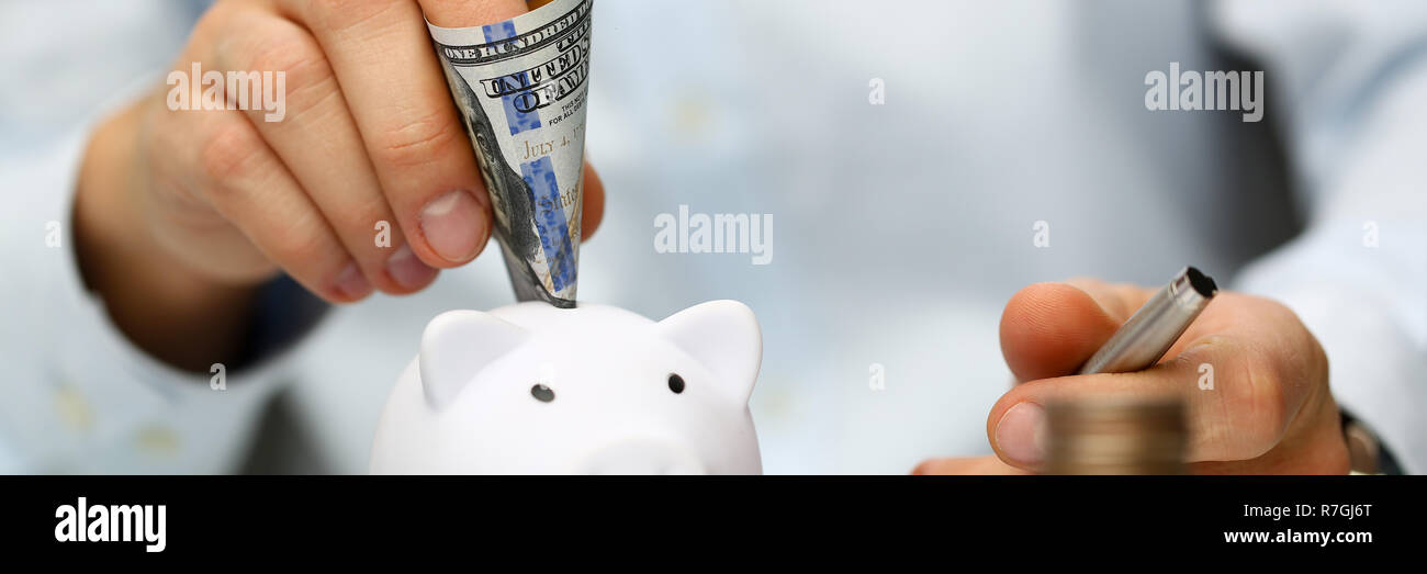 Hand businessman putting pin money Stock Photo - Alamy