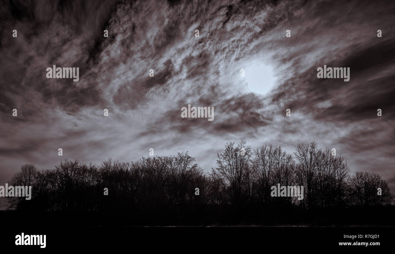 Dramatic monochrome sunset with high clouds and sun in the frame Stock ...