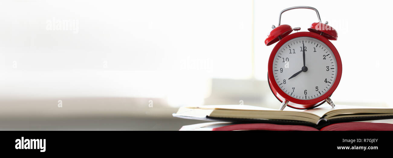 Red alarm clock set at eight in the morning Stock Photo - Alamy
