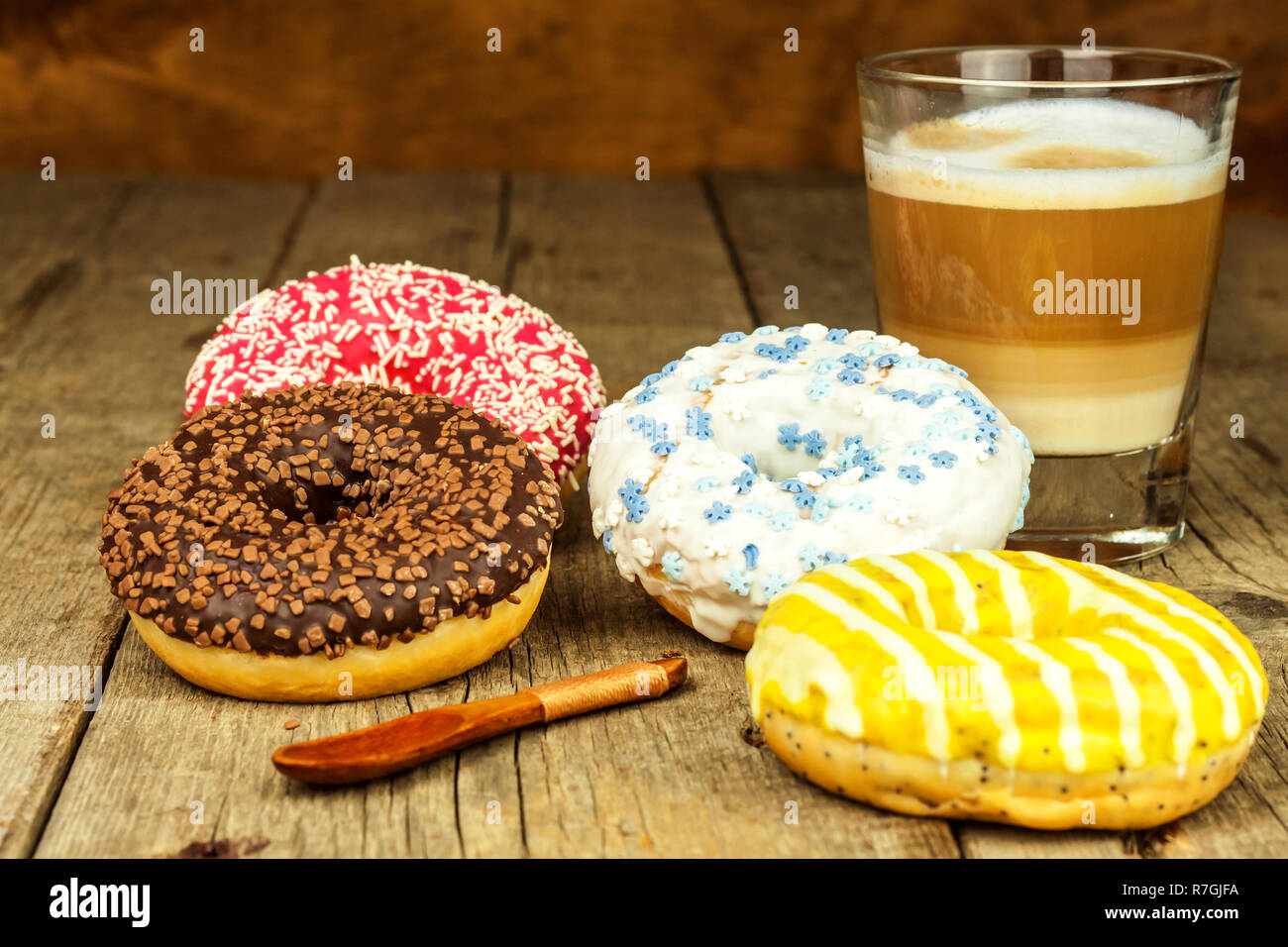 Unhealthy food. Donuts on a wooden table. Coffee to dessert. Dangers of ...