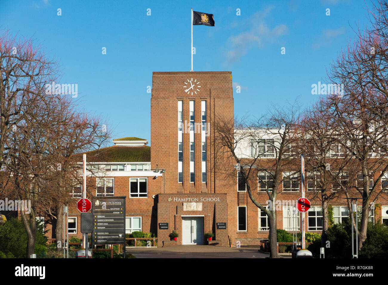 Front exterior facade of Hampton School with flag flying. It is an ...