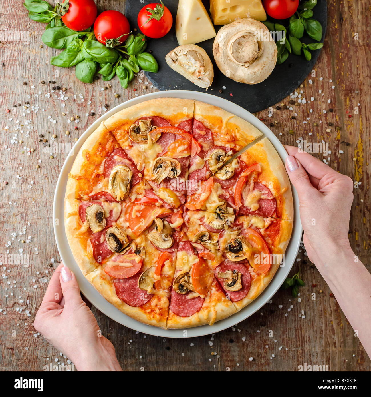 Hands take slices of pizza hi-res stock photography and images - Alamy