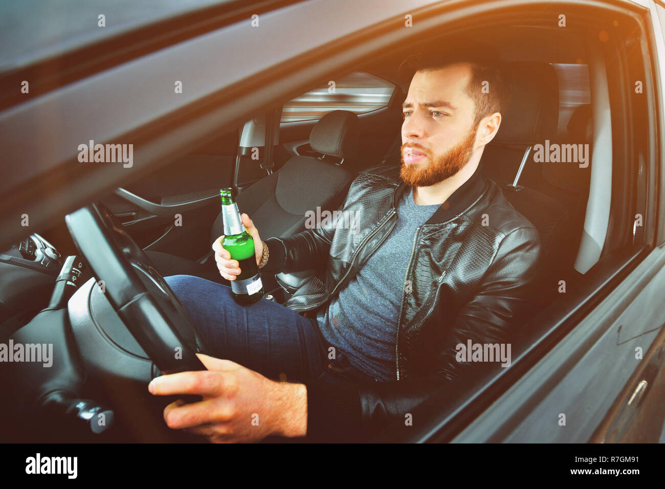 Hand holding beer bottle driving hi-res stock photography and images ...
