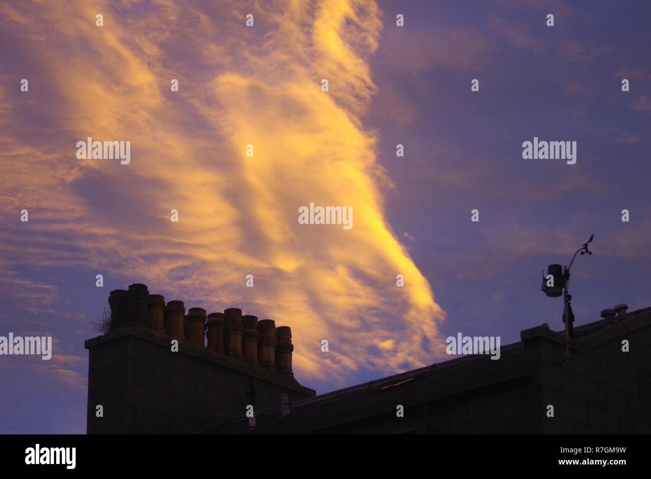Dramatic Purple and Orange Sunset Sky Silhouetting a Victorian House ...