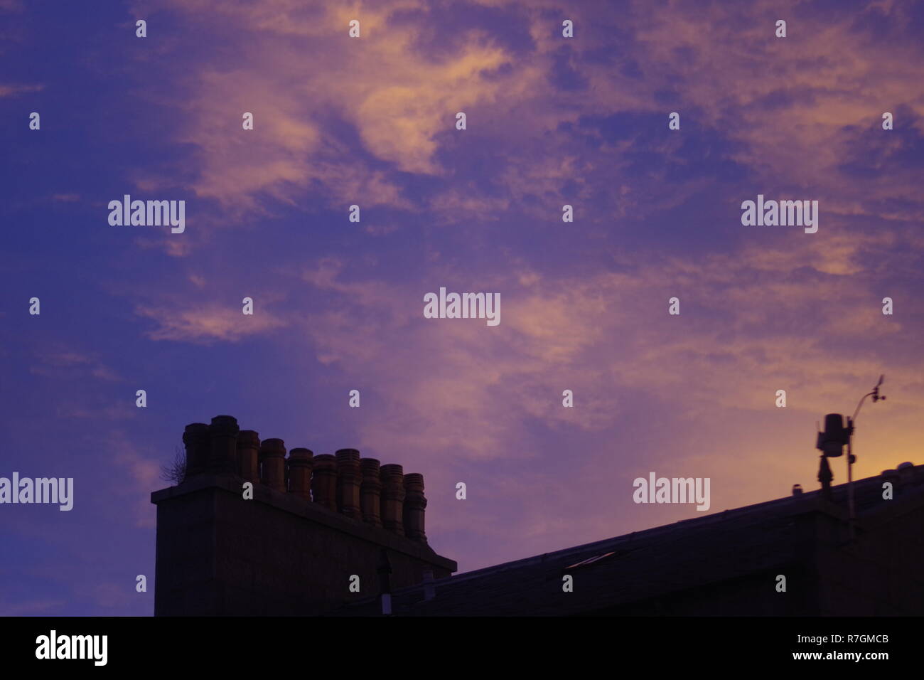 Dramatic Purple and Orange Sunset Sky Silhouetting a Victorian House ...