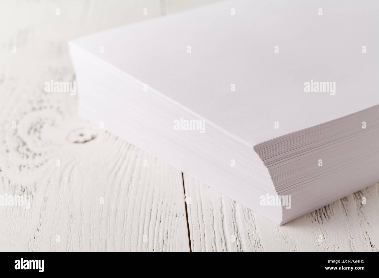 Stacked white paper on white background Stock Photo - Alamy