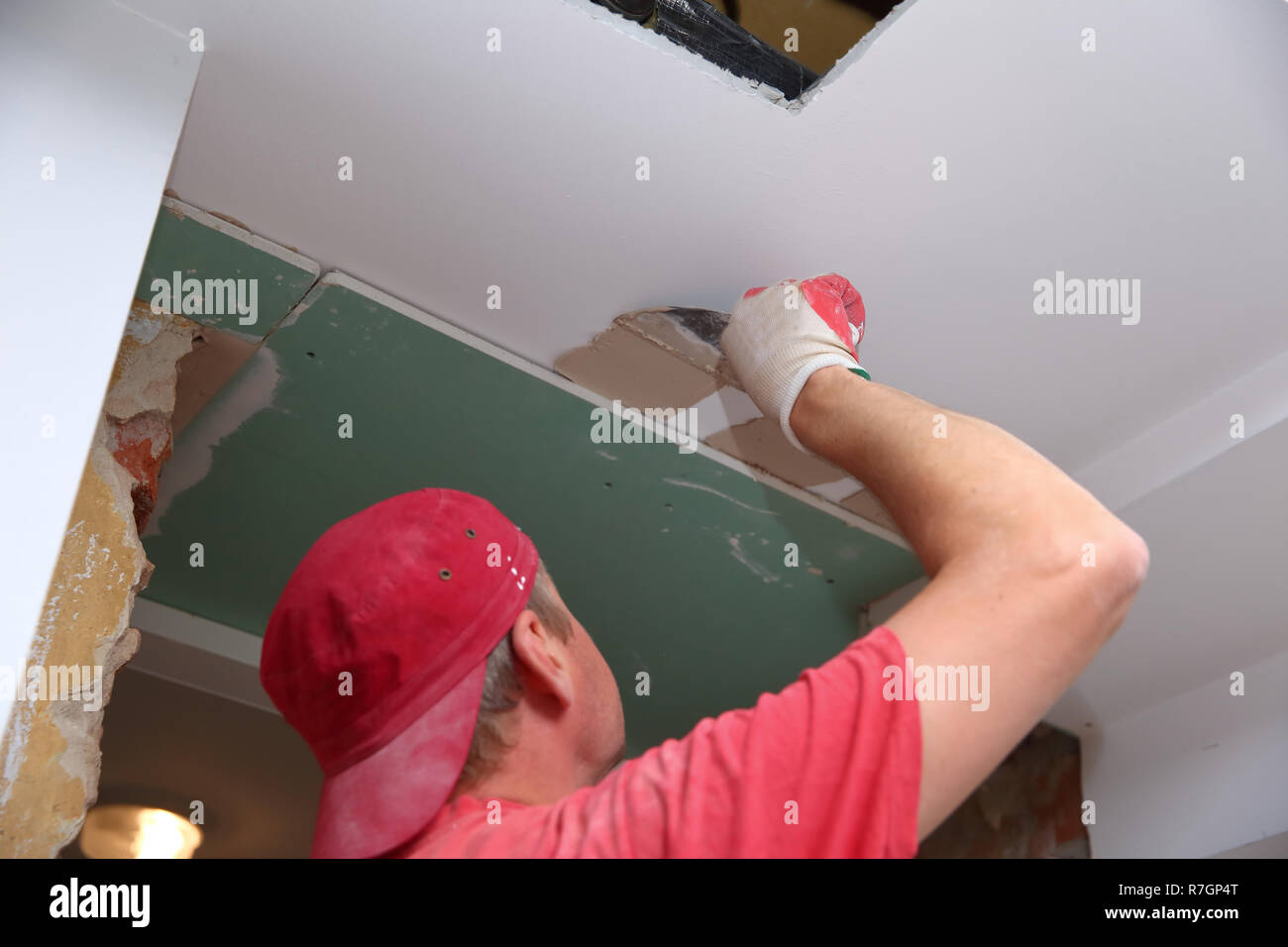 Filling walls and ceilings with plaster and gypsum plaster Stock Photo ...