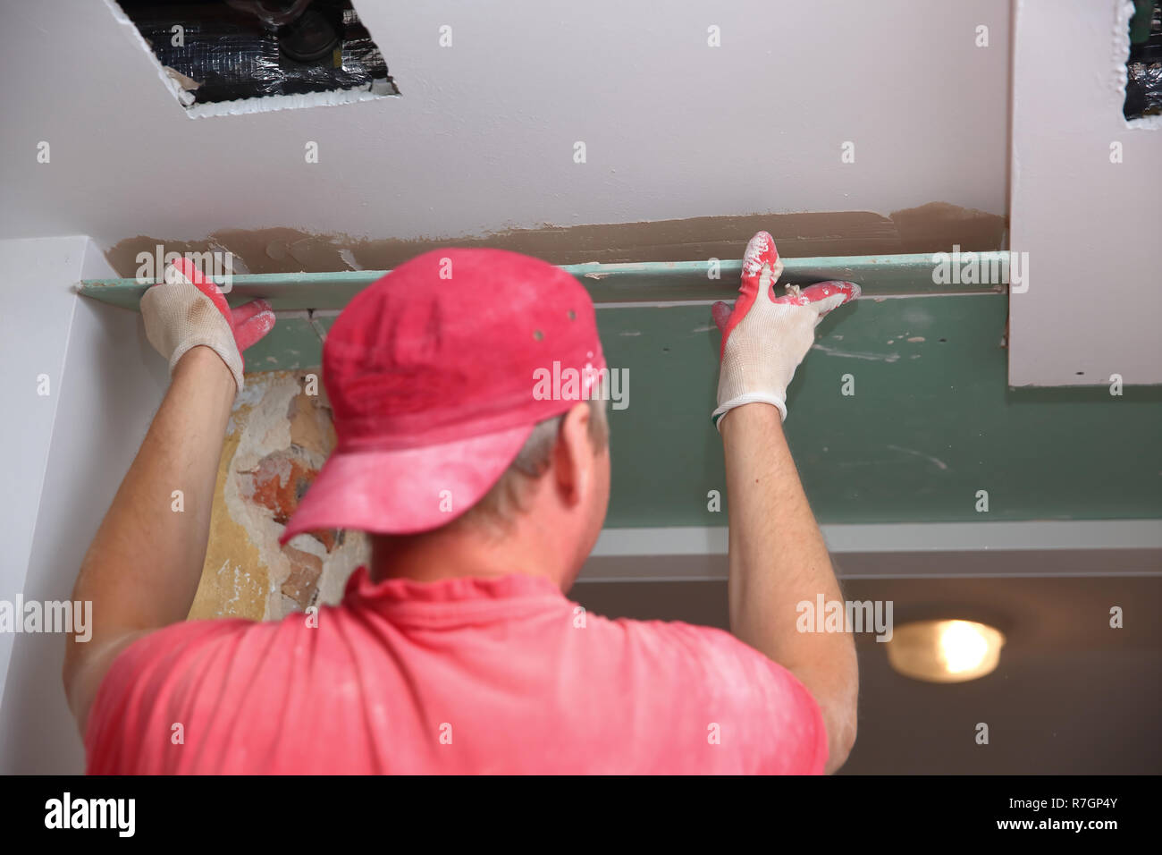 Filling walls and ceilings with plaster and gypsum plaster Stock Photo ...