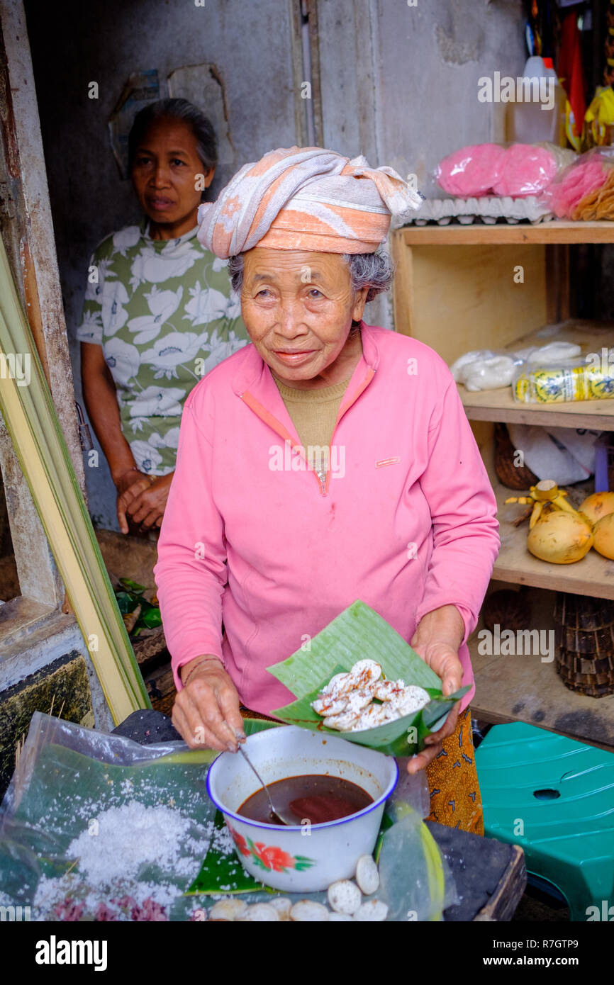 An elderly lady manning a market stall in Bali, Indonesia Stock Photo ...