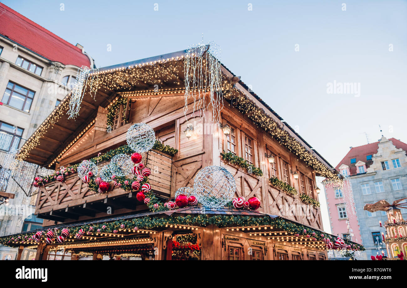 Illuminated Christmas fairground with wooden kiosk with a lot of bright ...