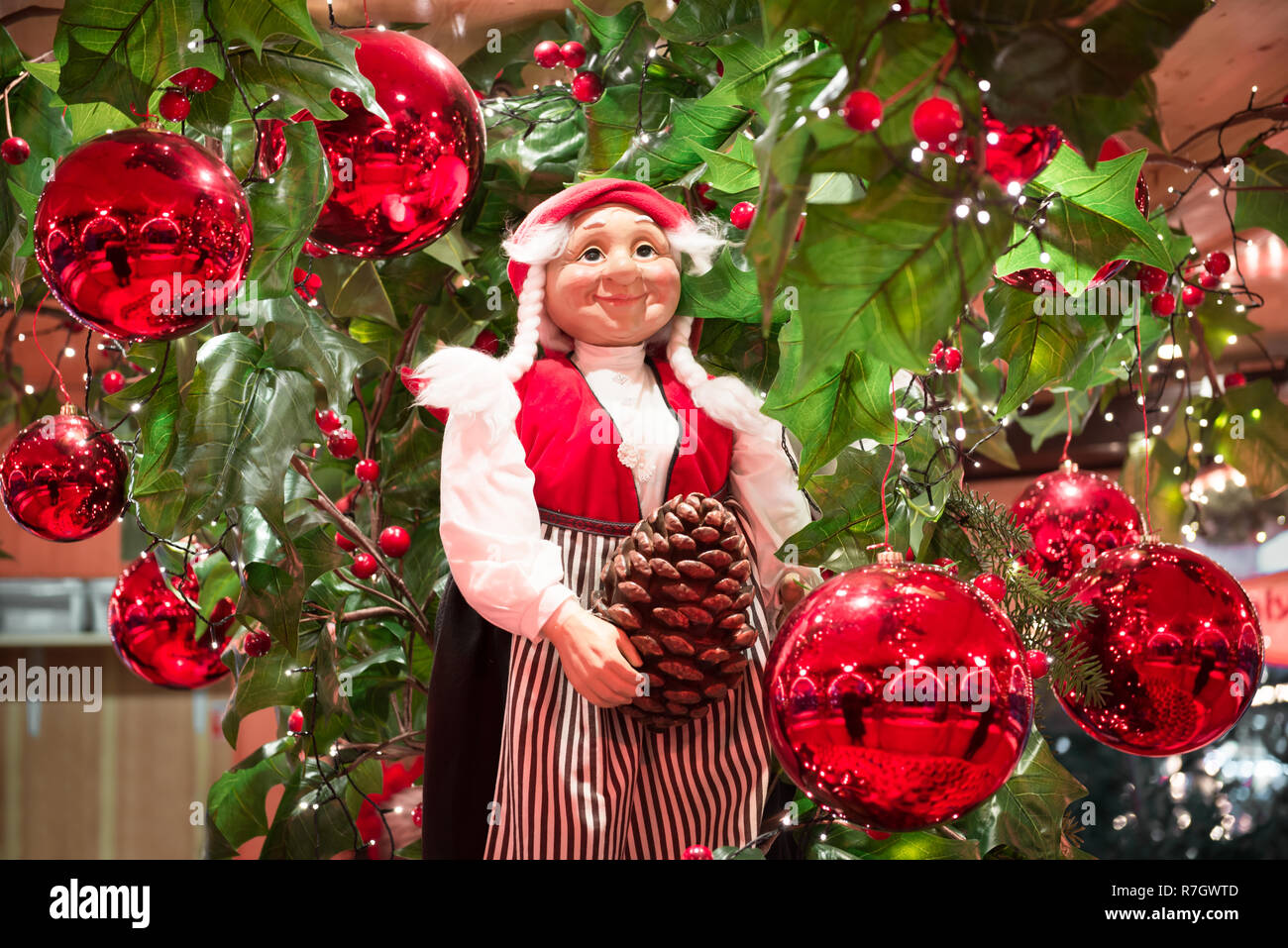 Illuminated Christmas fairground with installation with a doll and lot ...