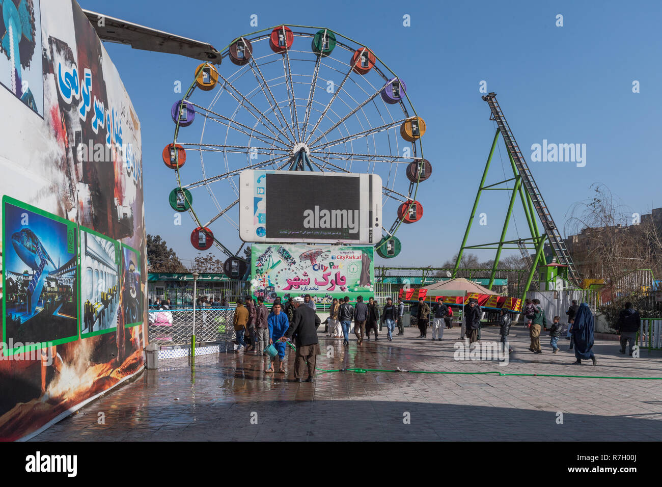 Visitors in Front of Ferris Wheel at City Park Amusement Park, Kabul ...