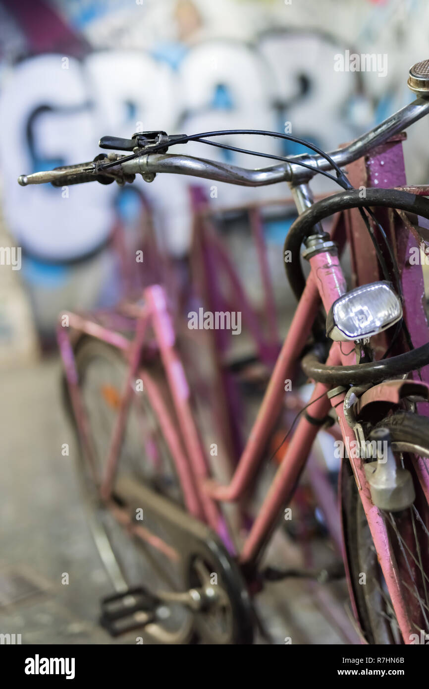The attached old rundown bicycle in pink Stock Photo - Alamy