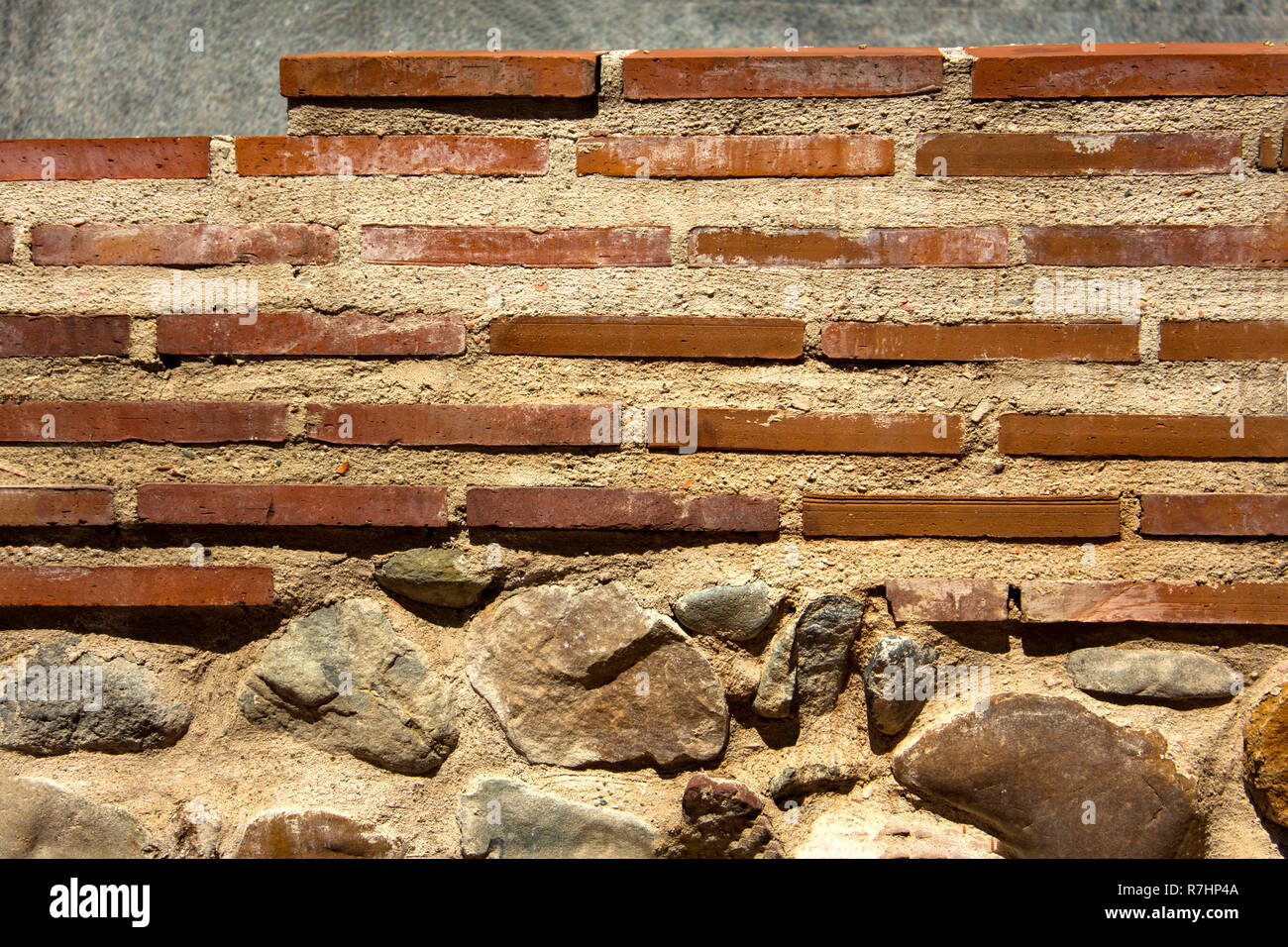 Wall reddish bricks and concrete Stock Photo - Alamy
