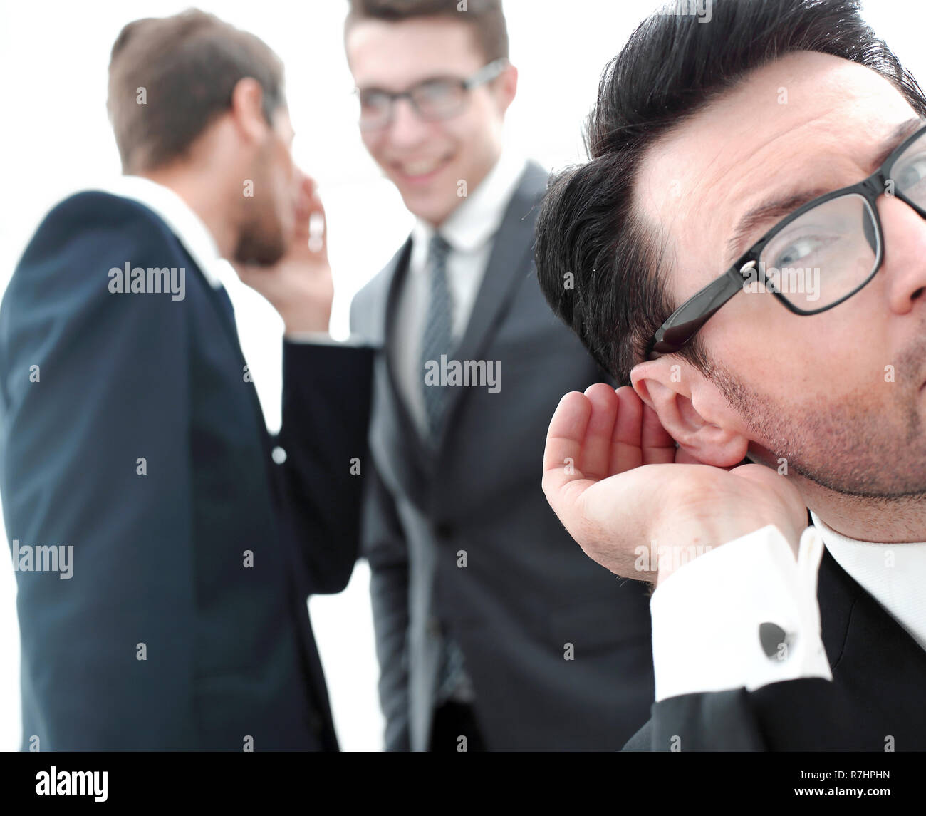 close up.businessman eavesdropping on conversation between colleagues ...