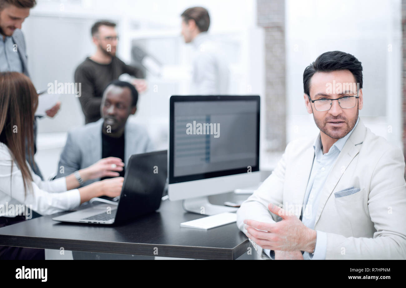Manager sitting at the office Desk Stock Photo - Alamy