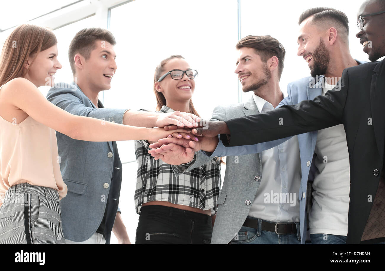 Group of business people piling up their hands together in the w Stock ...
