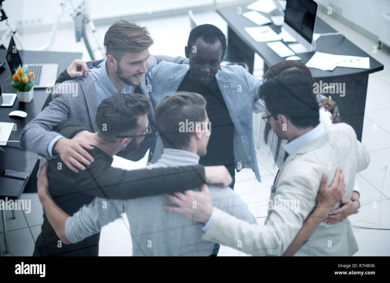 close up.business team hugging each other Stock Photo - Alamy