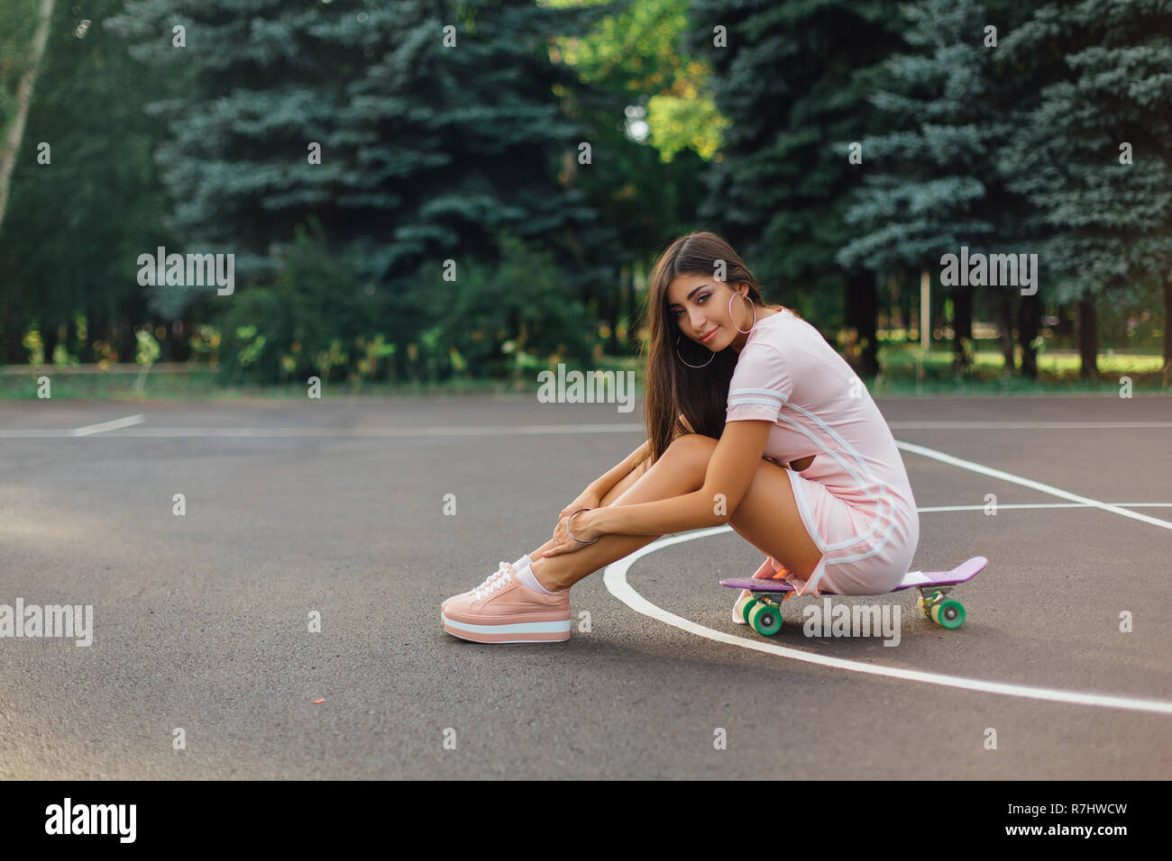 Portrait of a smiling charming brunette female sitting on her ...