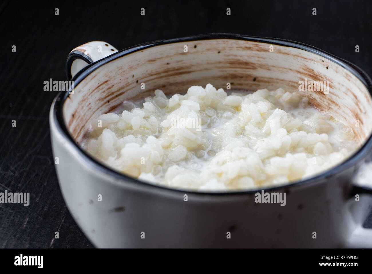 rice pudding in white plate on dark background Stock Photo - Alamy