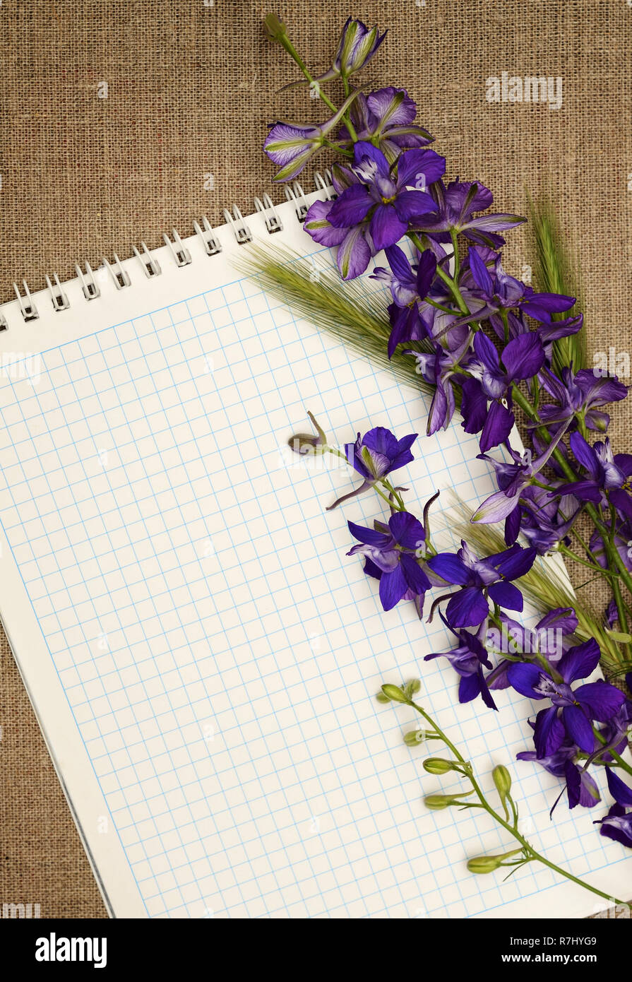 Note and flowers on canvas background Stock Photo - Alamy