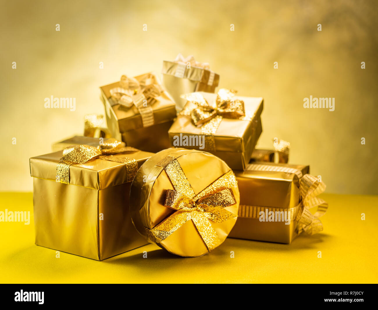 Golden gift boxes as a symbol of wishes and celebration. Golden blurred ...