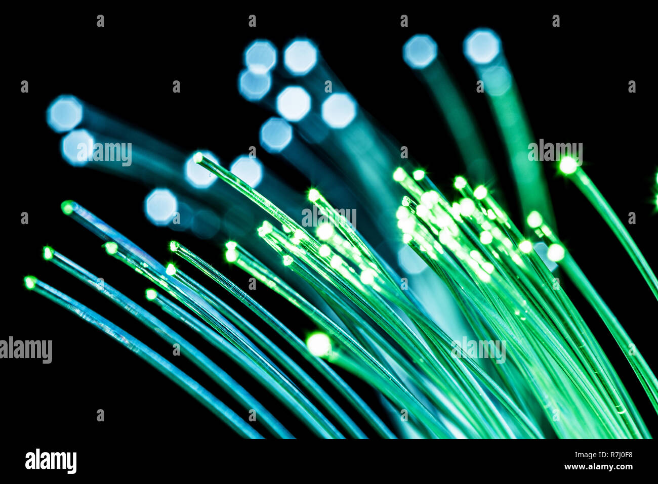 Bundle of optical fibers with green light. Black background Stock Photo ...